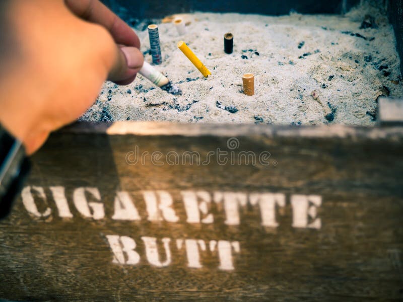 Cigarette on sand stock image. Image of hand, cigar - 146966553