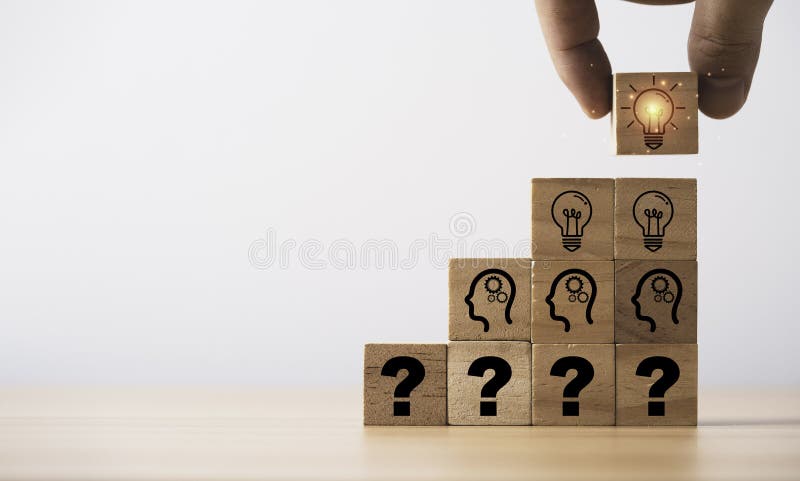 Hand Putting Wooden Cube Block Stacking Which Print Screen of Glowing Light Bulb and Question ...