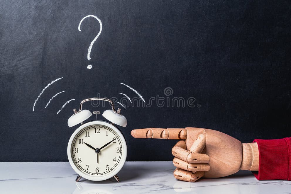 Hand Reaches for an Alarm Clock with a Question Mark Stock Photo ...