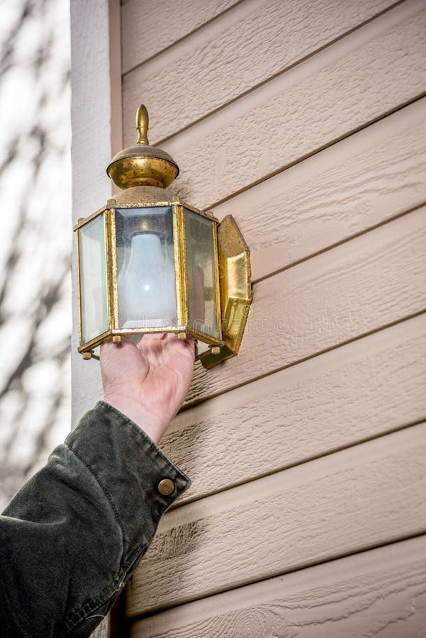 Hand Reaches in To Replace a Light on the Side of a House Stock Image ...