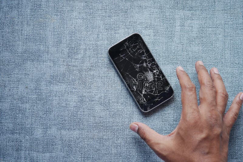 Hand Reaching from a Broken Smart Phone on Table Stock Photo - Image of ...