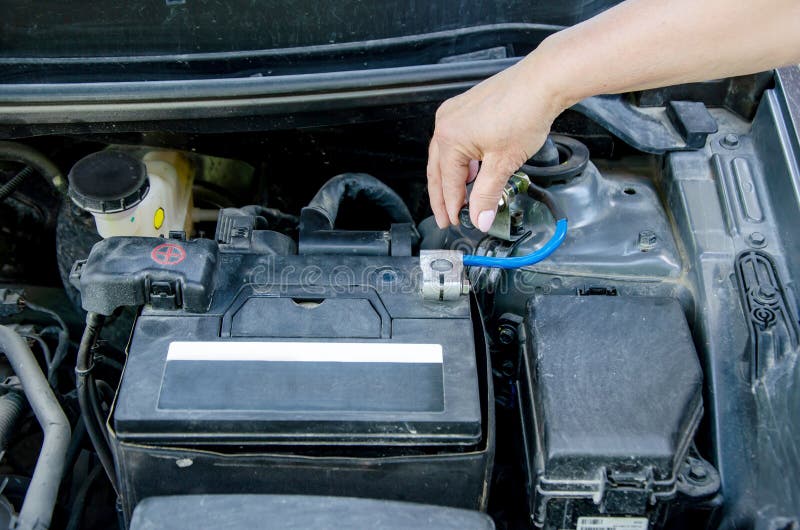 Hand Adjusting Car Battery Connection in Engine Compartment Stock Photo ...