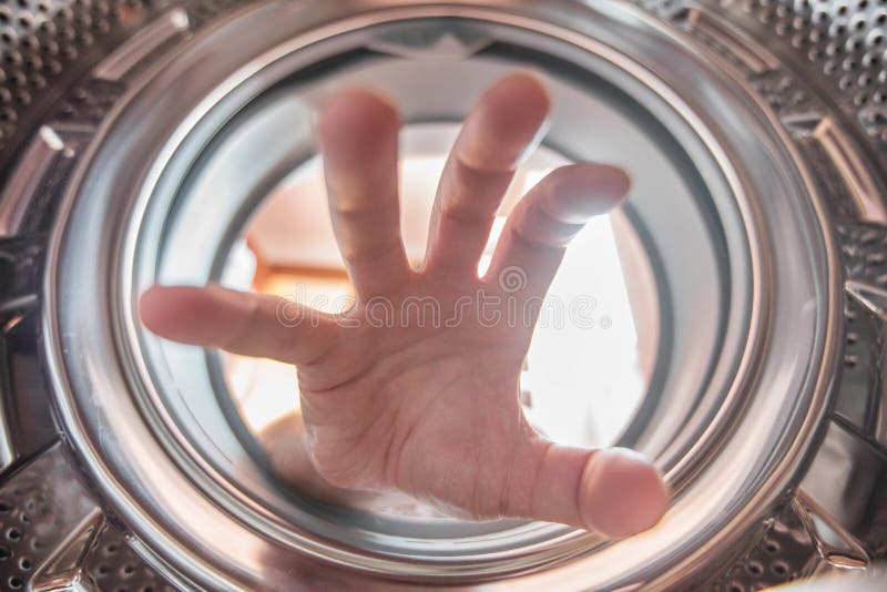 A Hand is Reaching Clothes Inside the Washing Machine. Stock Image ...