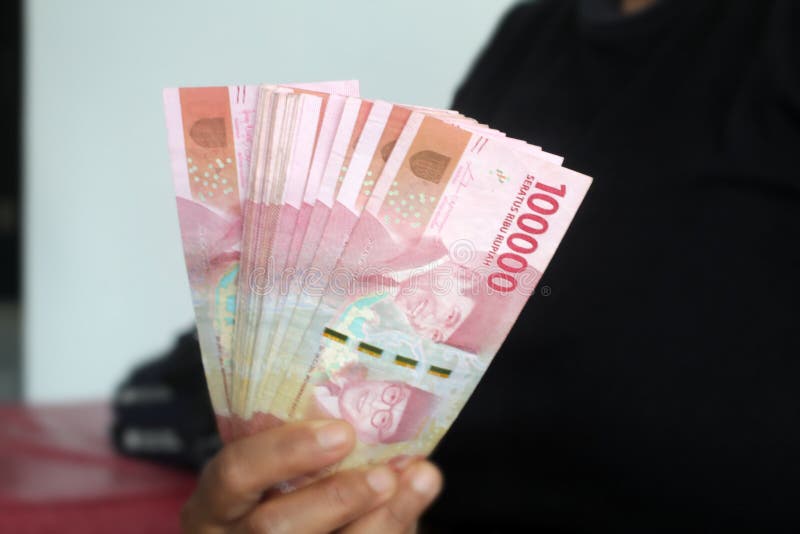 Hand with Red Indonesia Rupiah Money. Stock Photo - Image of flow, give ...