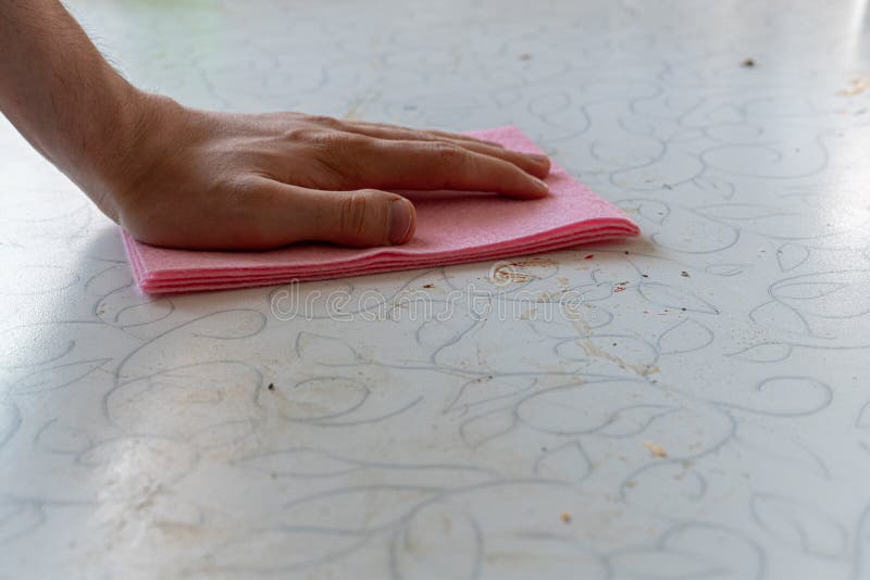 Hand with a Red Rag Wiping the Dirty Table Surface in Kitchen at Home ...