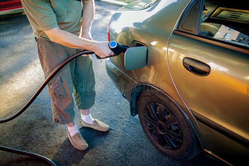 Hand Refilling the Car with Fuel at the Refuel Station. Stock Photo ...