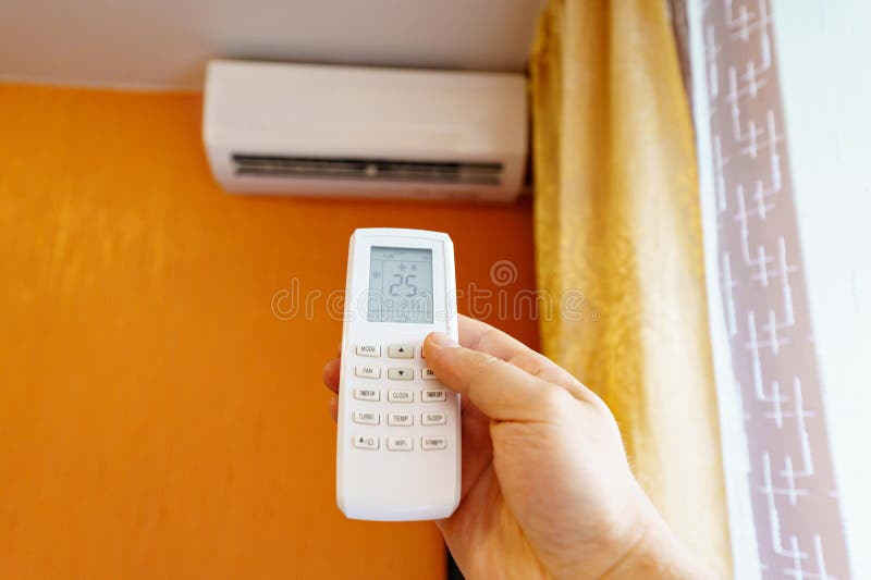 Hand with the Remote Control of the Air Conditioner. Stock Photo ...