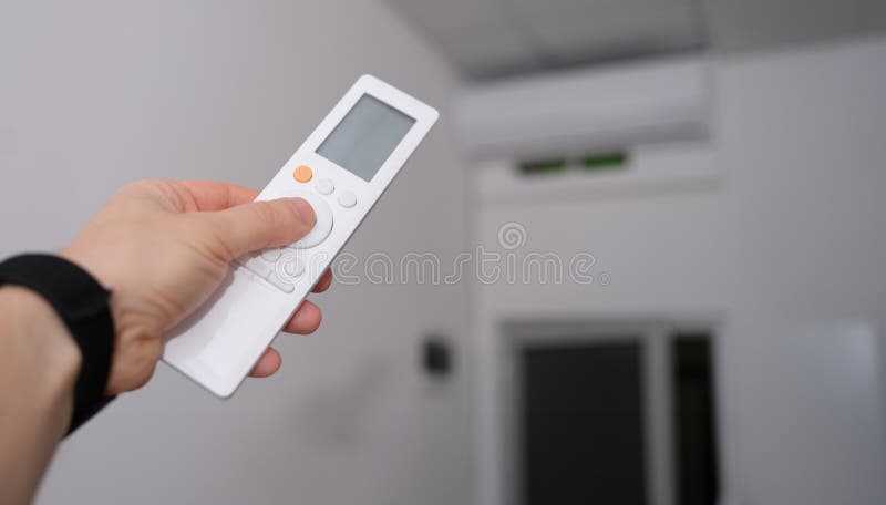 Hand with Remote Control is Directed To Air Conditioner in Room Stock ...