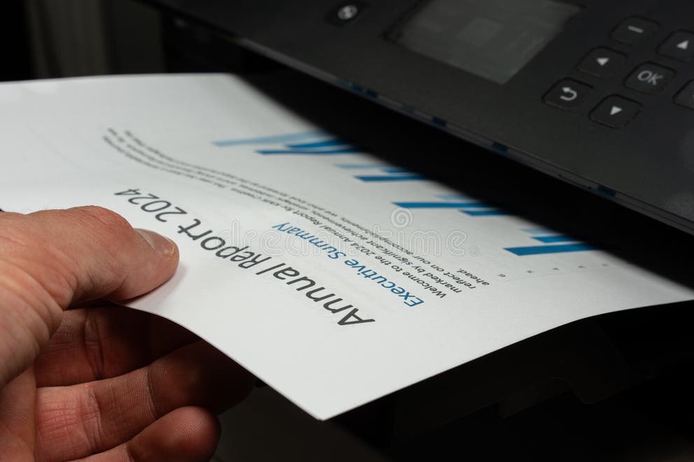 Hand Removing Printed Report from Printer Tray Showing Financial Chart and Data Visualization ...