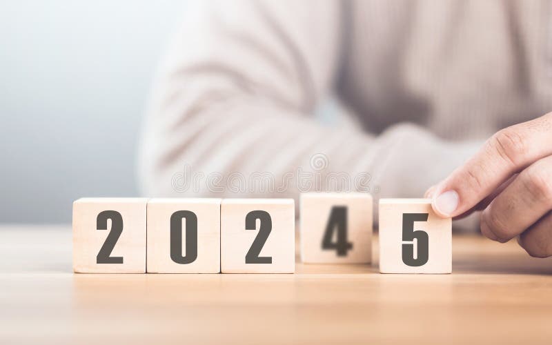 Hand Replaces 2024 with 2025 Using Number Blocks, Symbolizing the ...