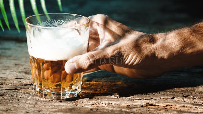 Hand rests glass of beer stock photo. Image of october - 257272274
