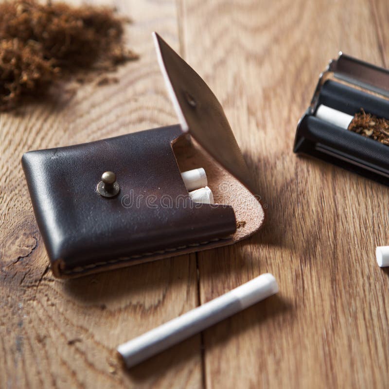 Hand rolling cigarettes stock photo. Image of equipment - 70676458