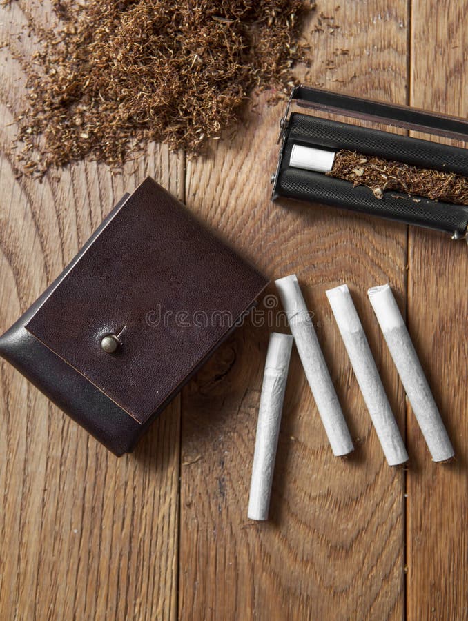 Hand rolling cigarettes stock photo. Image of addiction - 70677116