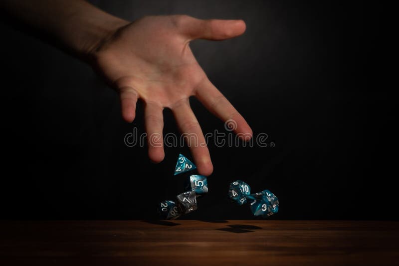 Hand Rolling Grey Polyhedral Dice Stock Image - Image of role, roll ...