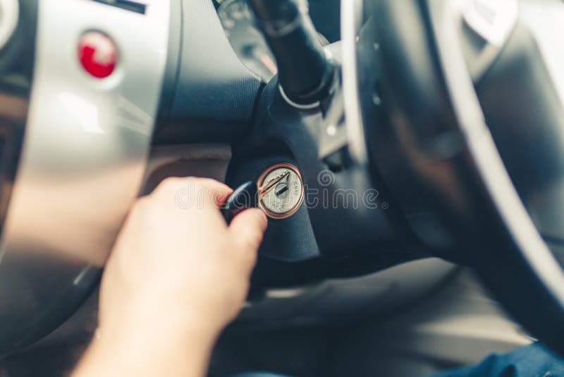 Hand S Man Plug in a Key Starting the Engine of a Car. Stock Photo ...
