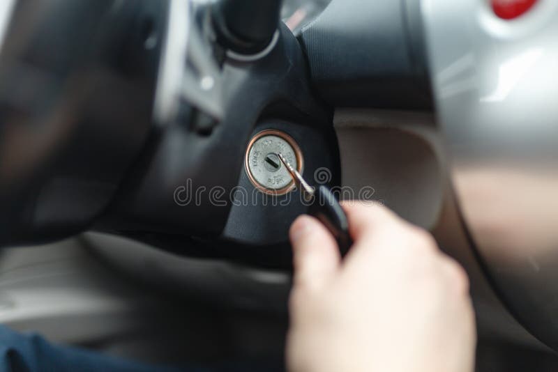 Hand S Man Plug in a Key Starting the Engine of a Car. Stock Photo ...