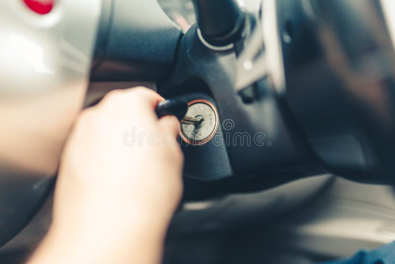 Hand S Man Plug in a Key Starting the Engine of a Car. Stock Photo ...
