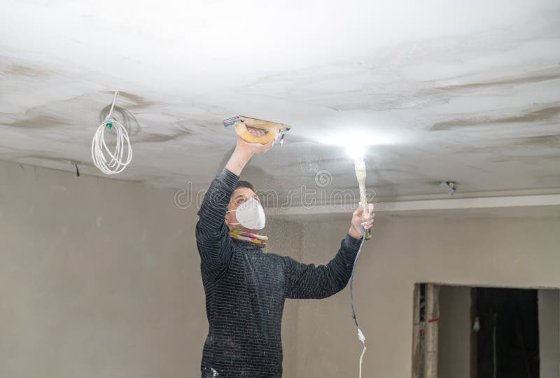 Sanding a Plasterboard Ceiling in a New Building with a Trowel Stock ...