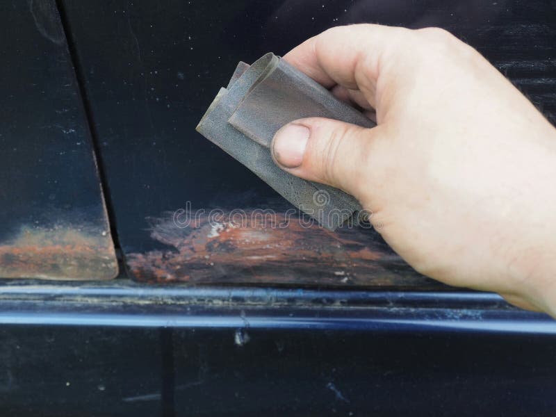 Hand with Sandpaper. Rust Removal from the Car Stock Photo - Image of ...