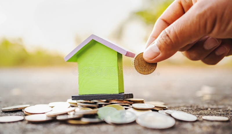 Hand Saving Money with Mini House and Coins Stack Stock Image - Image ...