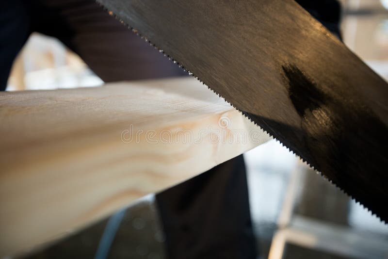 Hand Saw Cutting Wooden Plank at Site Stock Image - Image of profession ...