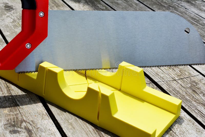 Hand Saw and a Yellow Miter Box To Make Precise Mitre Cuts. Stock Image ...