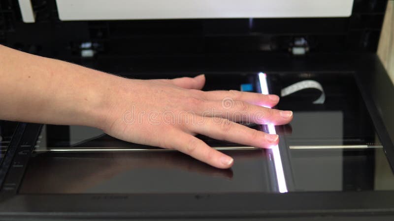 Hand Scanning Process. Scanner in Operation Scans a Human Hand with the ...