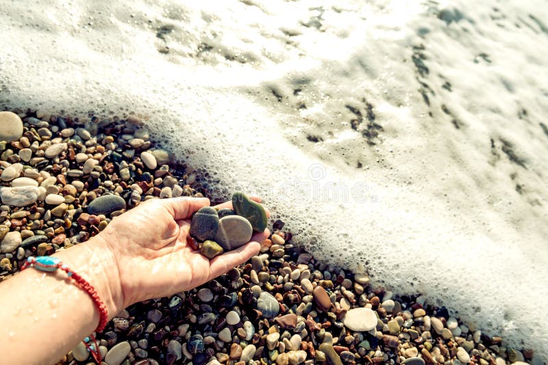 Hand with Sea Pebbles and Sea Foam and Wave Stock Photo - Image of hand ...