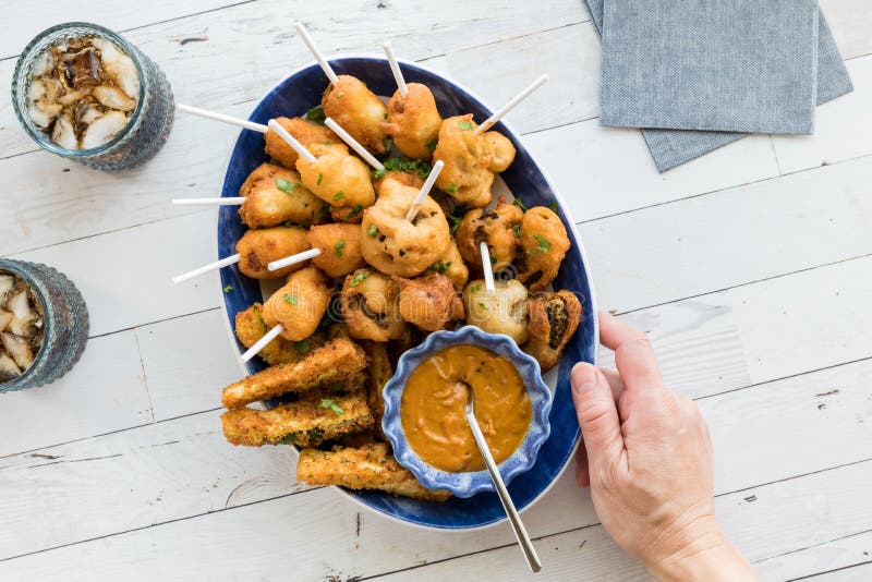 A Hand Serving a Platter of Deep Fried Appetizers, for Sharing. Stock ...