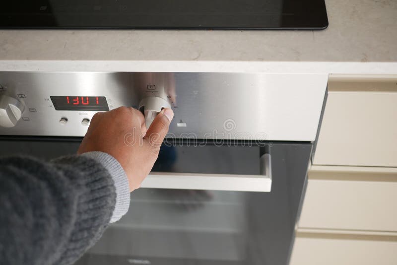 Hand Setting Temperature Control on Oven. Stock Photo - Image of ...