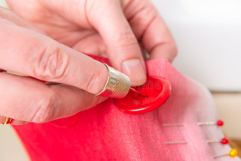 Hand Sewing Button on Fabric Stock Photo - Image of handmade, craft ...