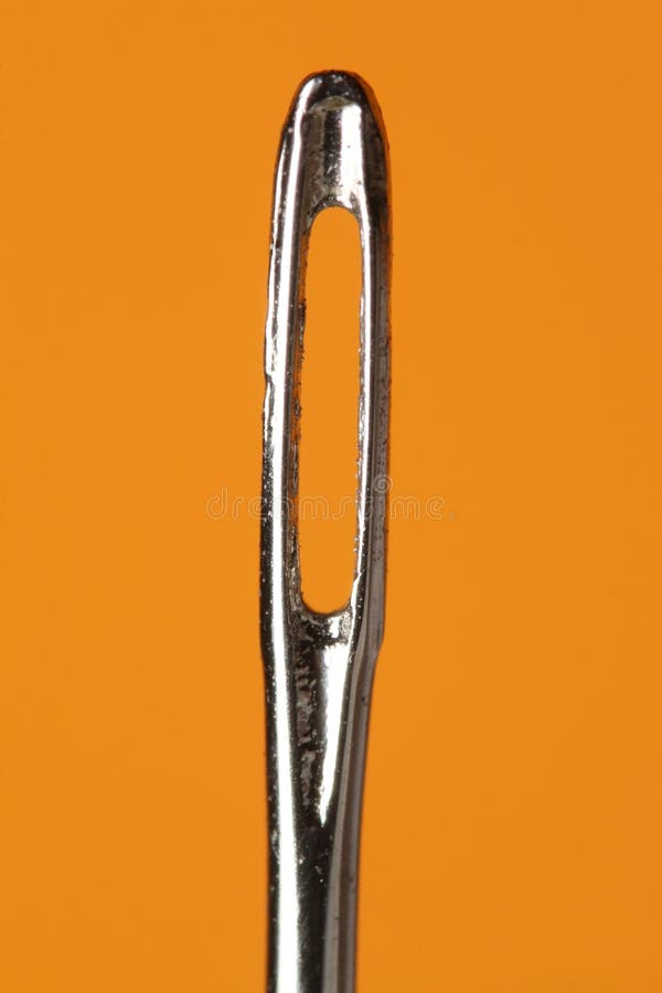 Hand Sewing Needle of Gray Color on an Orange Background Stock Image ...