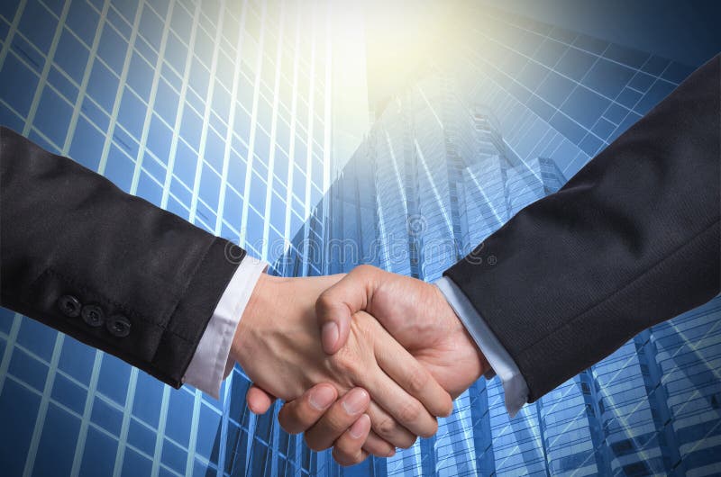 Hand Shake between a Businessman on Modern Glass Building Background ...
