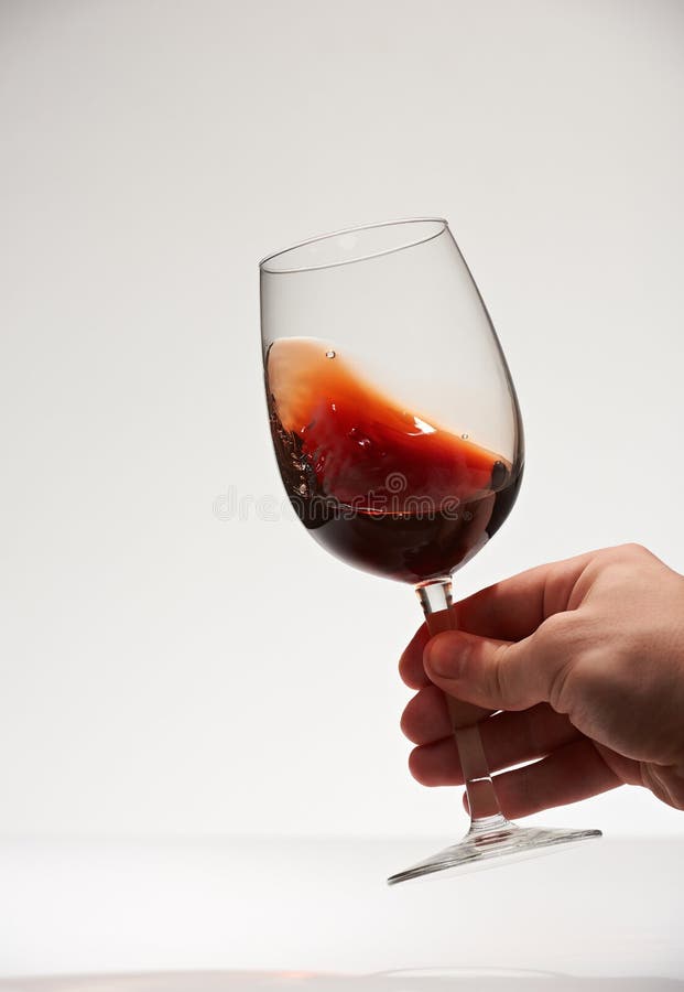 Hand Shaking Glass With Red Wine Stock Photo - Image of celebration ...
