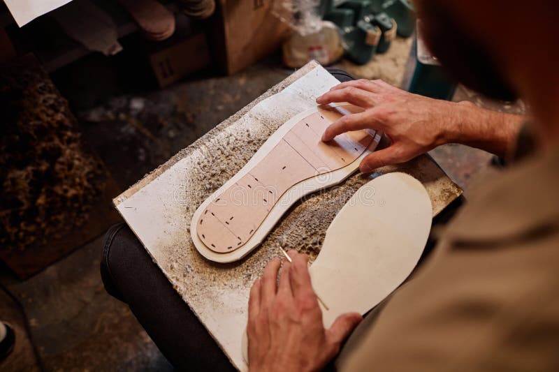 Hand of Shoemaking Master Putting Shape Sample on Boot Sole Workpiece ...