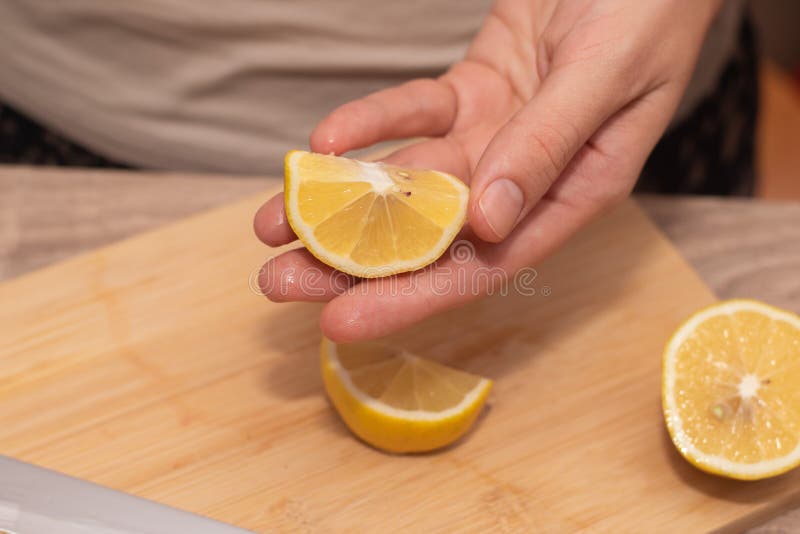 Hand Showcasing Half a Lemon. a Person& X27;s Fingers Displaying a ...