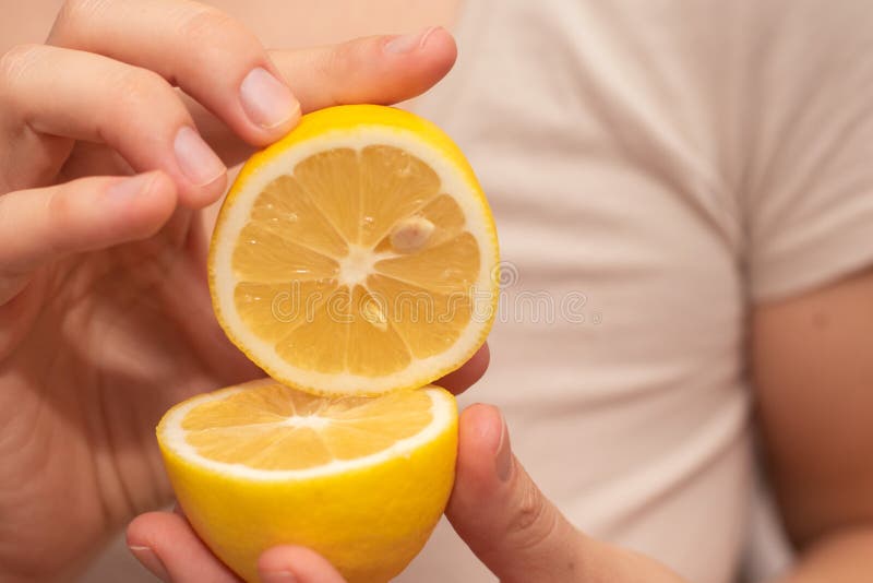 Hand Showcasing Half a Lemon. a Person& X27;s Fingers Displaying a ...