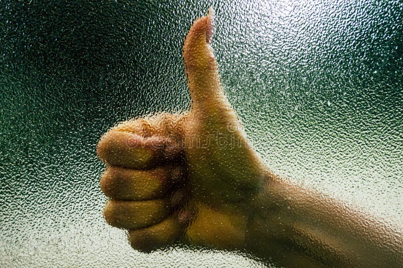 Hand Shows a Finger To the Top through Embossed Glass Stock Image ...