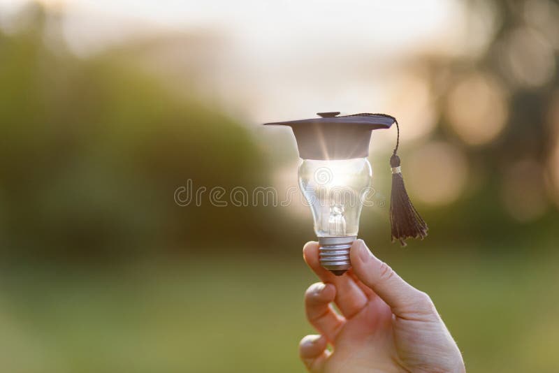 A Hand Shows a Light Bulb with an Academic Cap Stock Photo - Image of ...