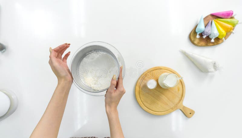Hand Sifting Flour in a Kitchen with Baking Ingredient and Colorful ...
