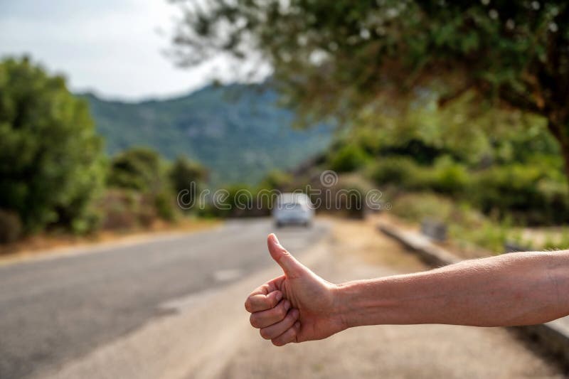 Hitchhiker Hitchhikes And Gives A Thumbs Up On A Road Stock Image