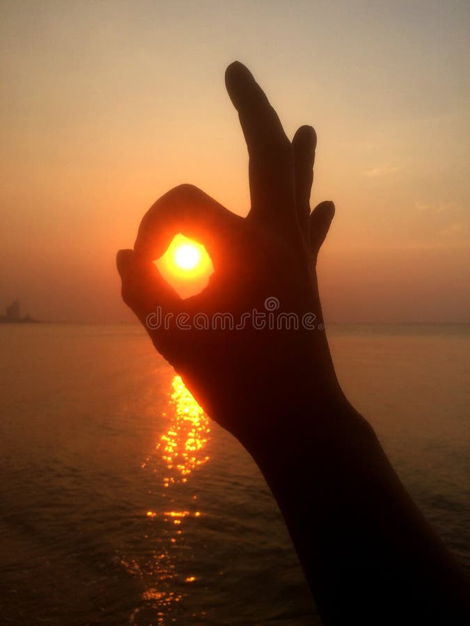 Hand Sign and Sun Rays Going through Hands at Sunset Stock Photo ...