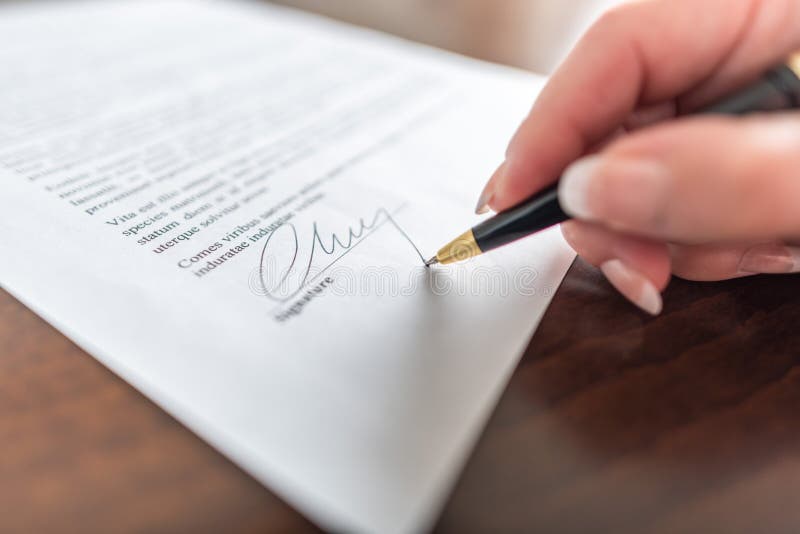 Hand signing a contract stock image. Image of agreement - 58507303