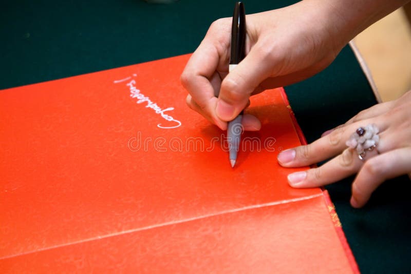 Hand Signing on a Red Guests Book Stock Photo - Image of document ...
