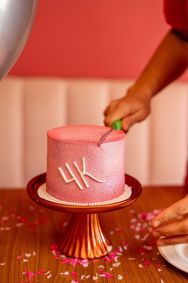 Hand slicing a pink cake stock image. Image of creamy - 381940585