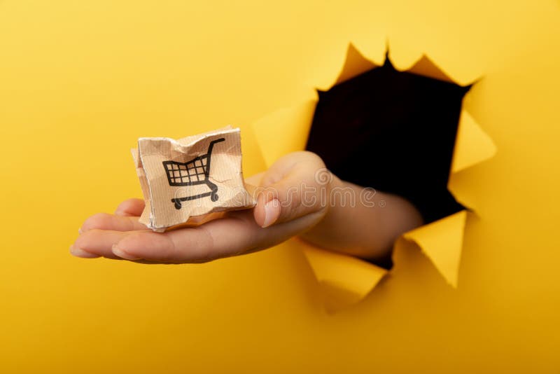 Hand with a Small Broken Delivery Box through a Yellow Paper Hole ...