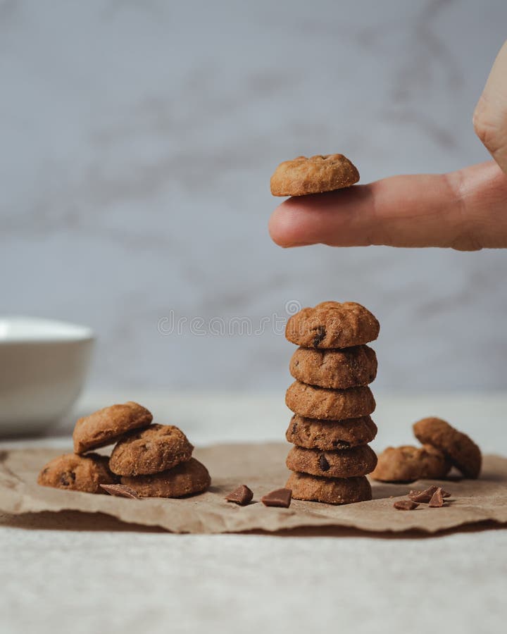 Hand with a Small Chocolate Chip Cookie on the Finger Stock Image ...