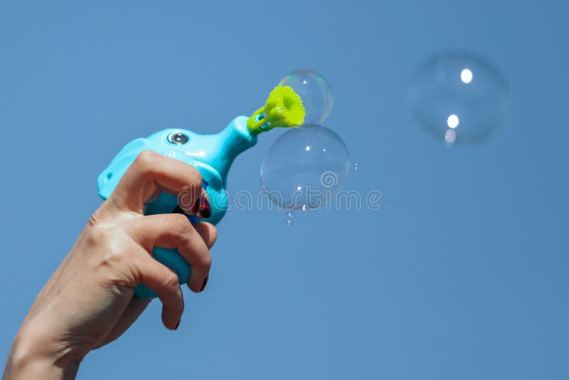 Hand with Soap Bubbles Against the Blue Sky Stock Photo - Image of ...