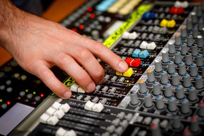 Hand of a Sound Manager on Sound Console Mixer. Equalizer Control ...