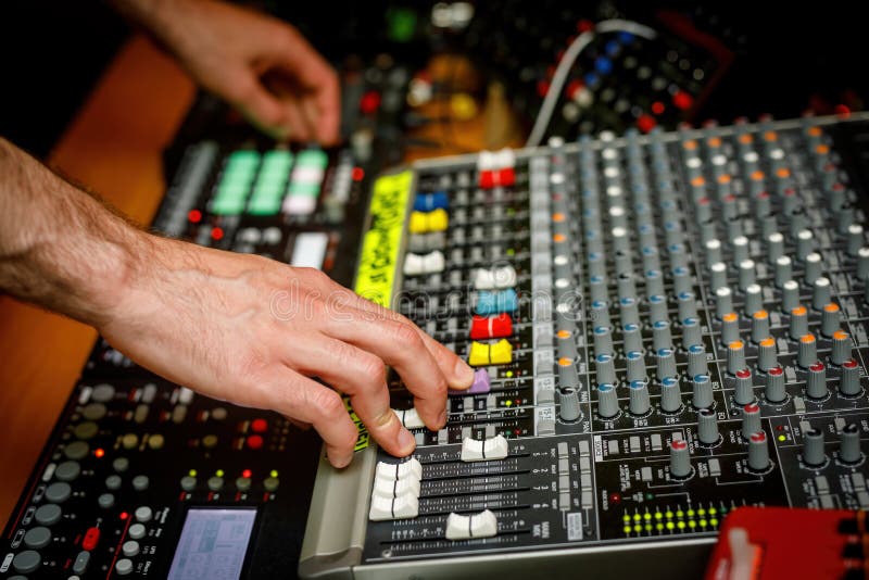 Hand of a Sound Manager on Sound Console Mixer. Equalizer Control ...